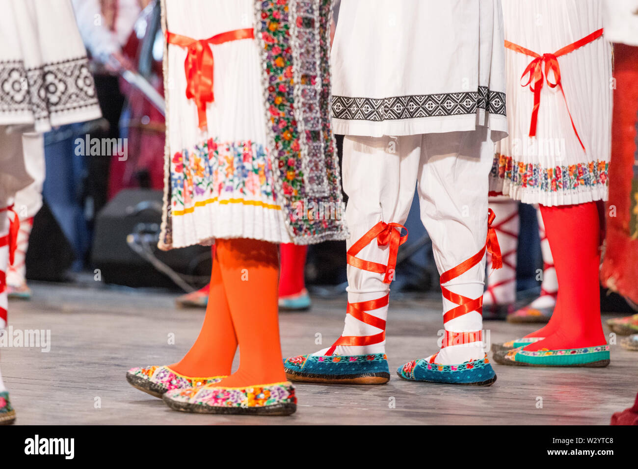 Close up of legs of young Romanian dancers perform a folk dance in ...
