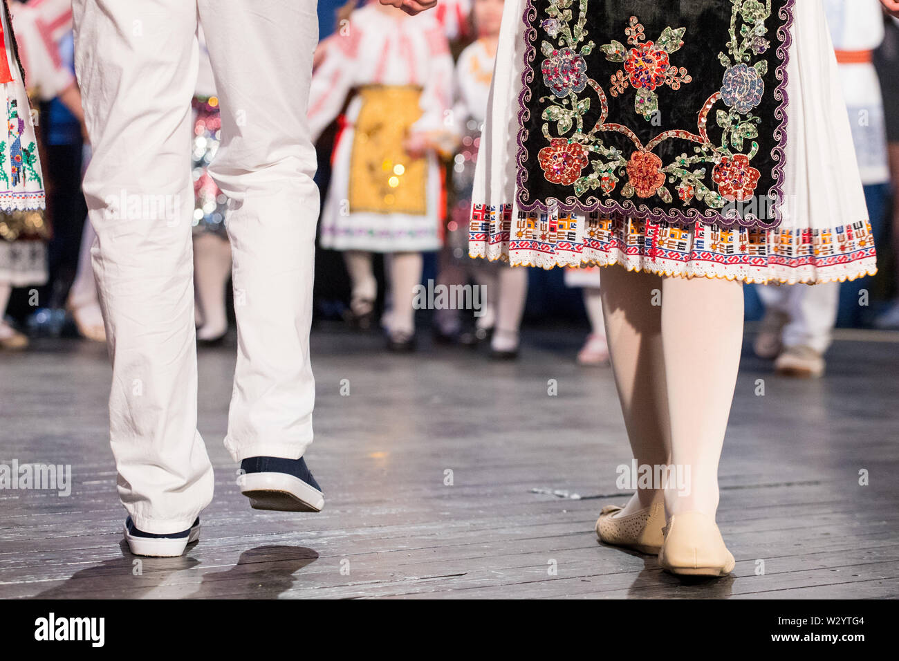 Close up of legs of young Romanian dancers perform a folk dance in ...