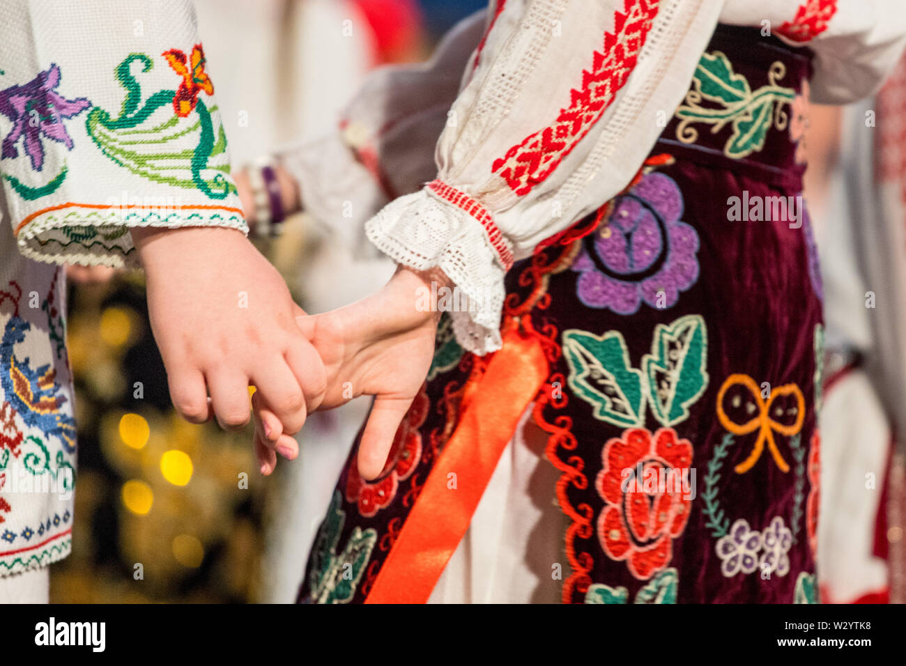 Close up of hands of young Romanian dancers perform a folk dance in ...