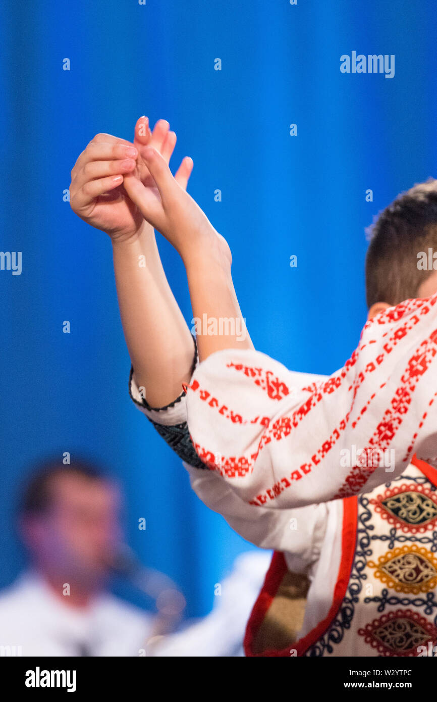 Close up of hands of young Romanian dancers perform a folk dance in ...