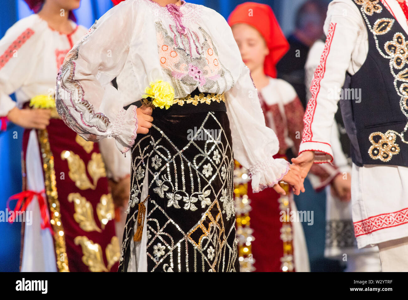 Close up of hands of young Romanian dancers perform a folk dance in ...