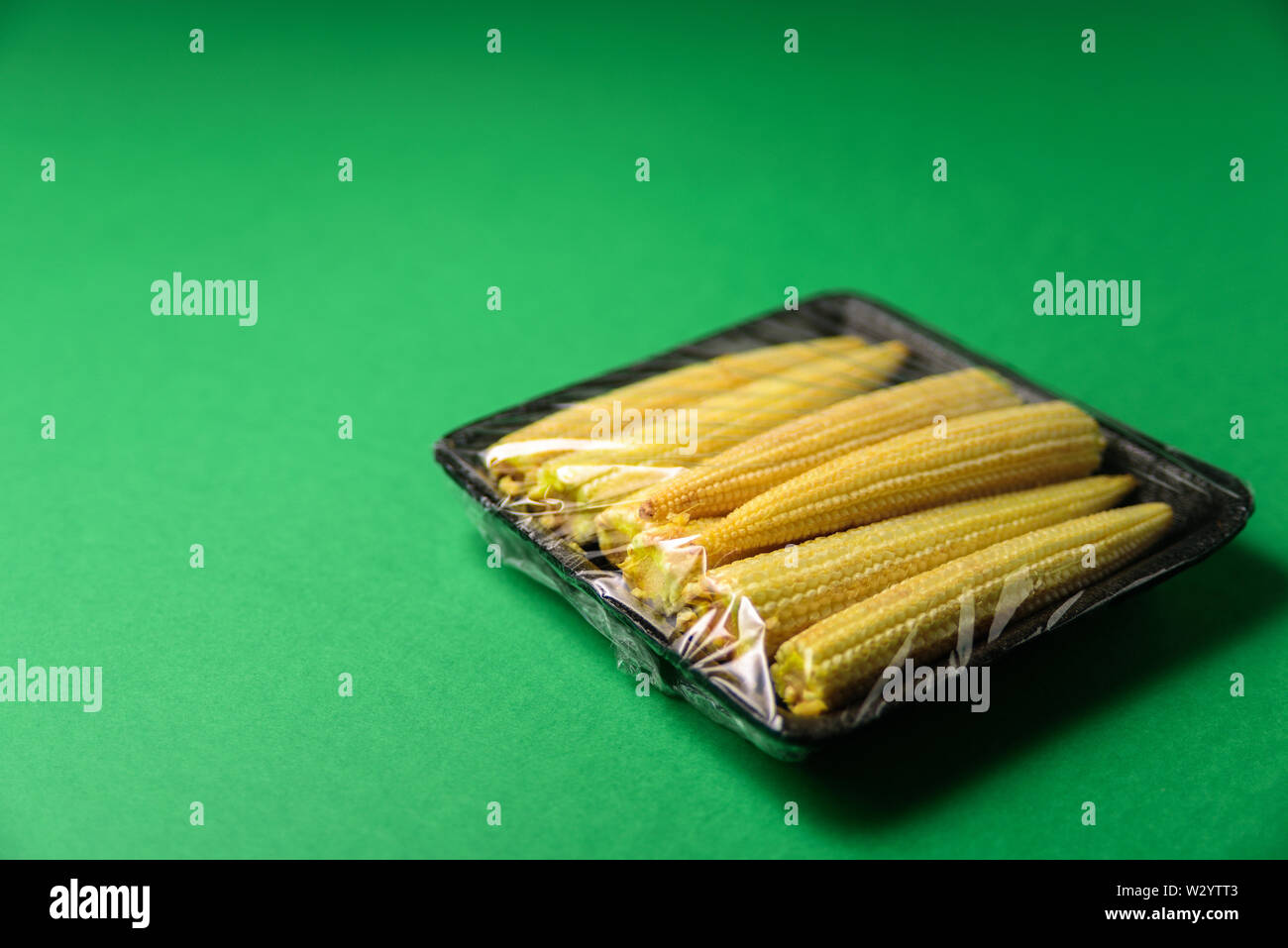 Fresh baby corn in plastic package. Zero waste, recycle concept ...