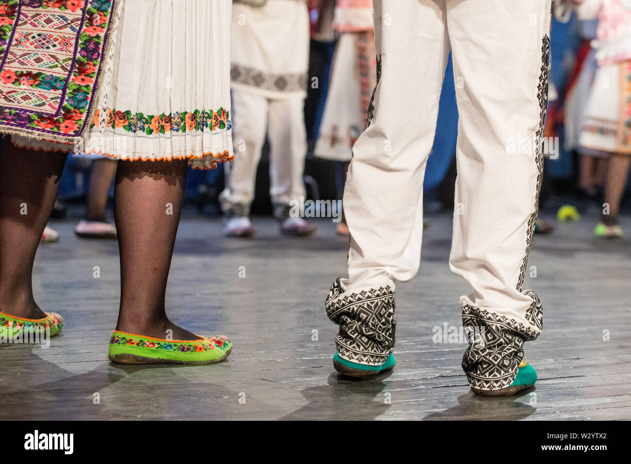 Close up of legs of young Romanian dancers perform a folk dance in ...