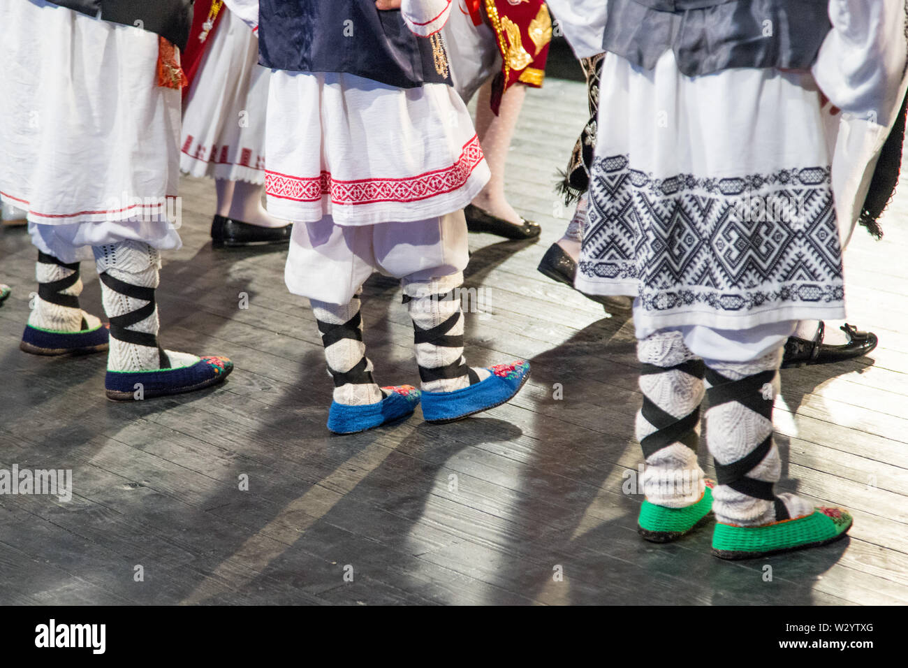 Close up of legs of young Romanian dancers perform a folk dance in ...
