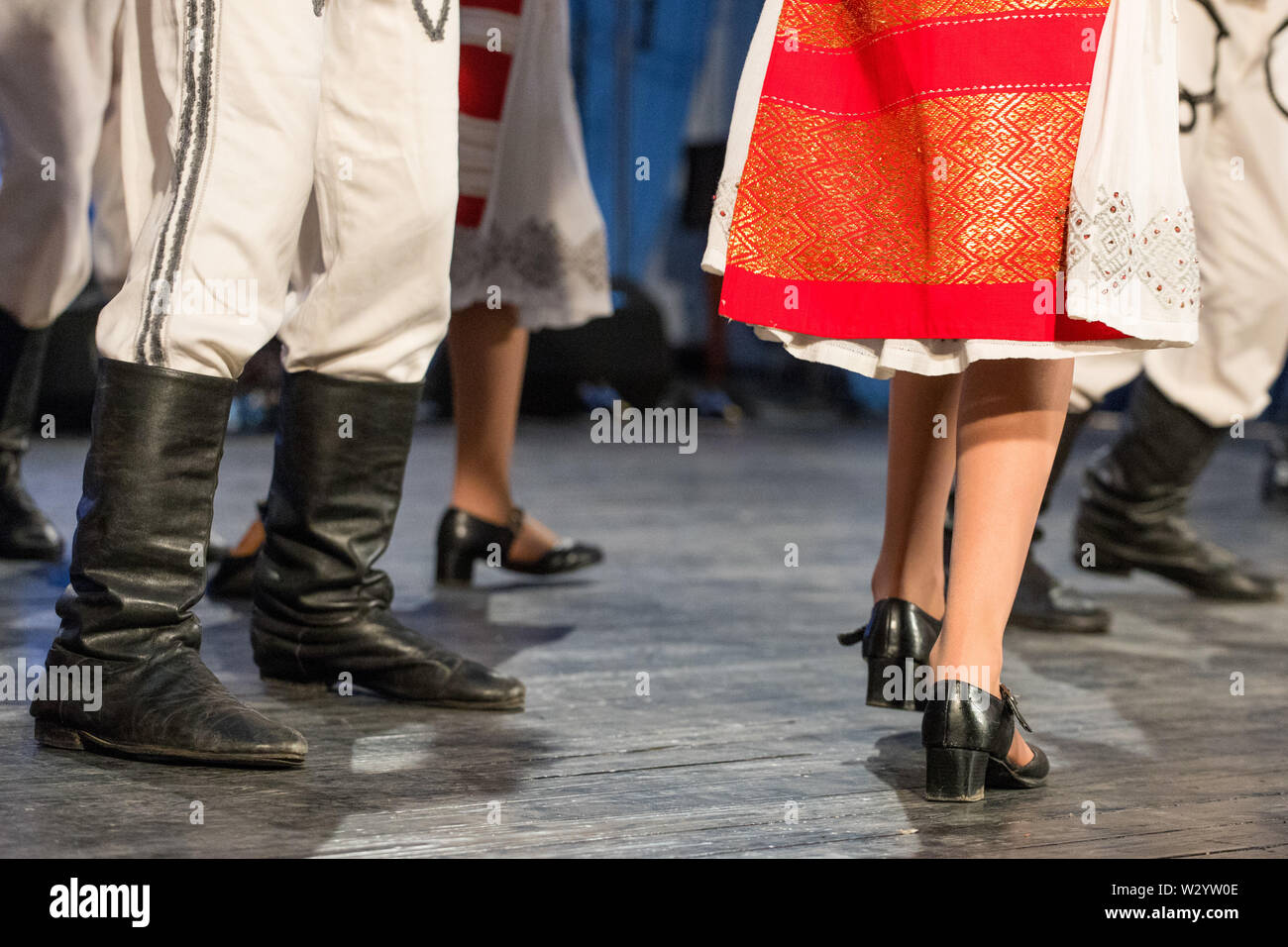 Close up of legs of young Romanian dancers perform a folk dance in ...