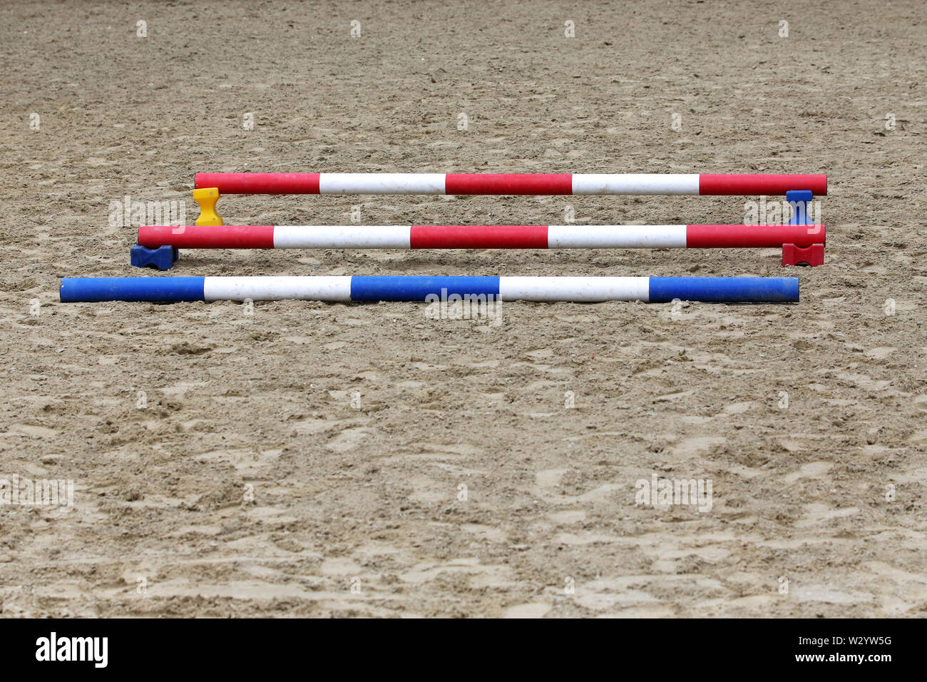 Colorful barriers on the ground for jumping horses and riders at riding ...