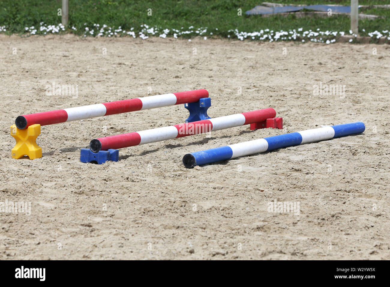 Colorful barriers on the ground for jumping horses and riders at riding ...