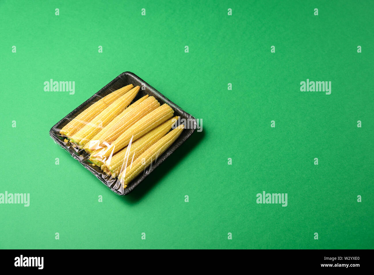 Fresh baby corn in plastic package. Zero waste, recycle concept ...