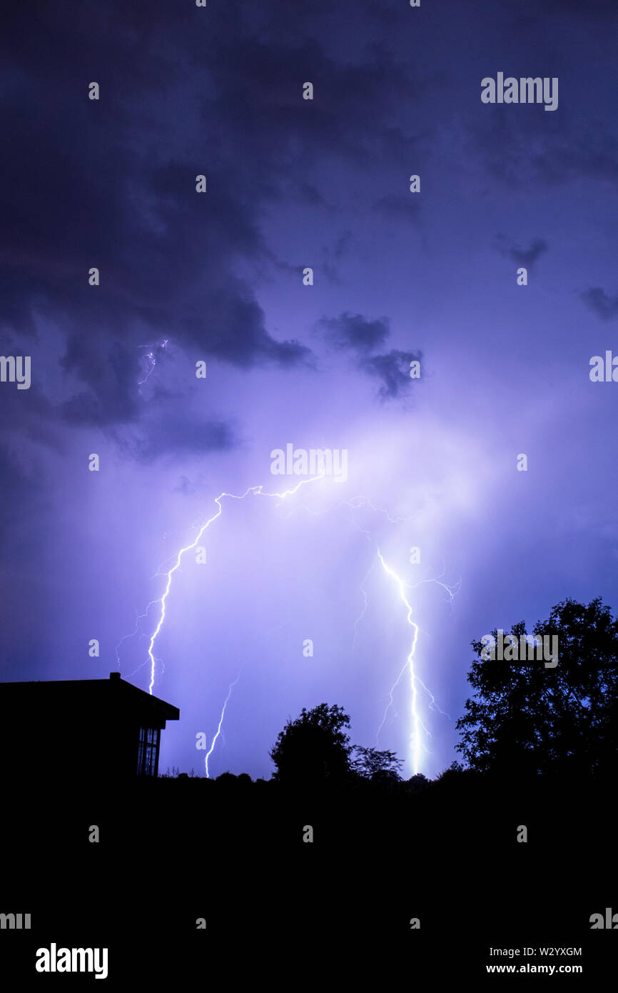 Lightning flashes over the night sky during thunderstorm Stock Photo ...