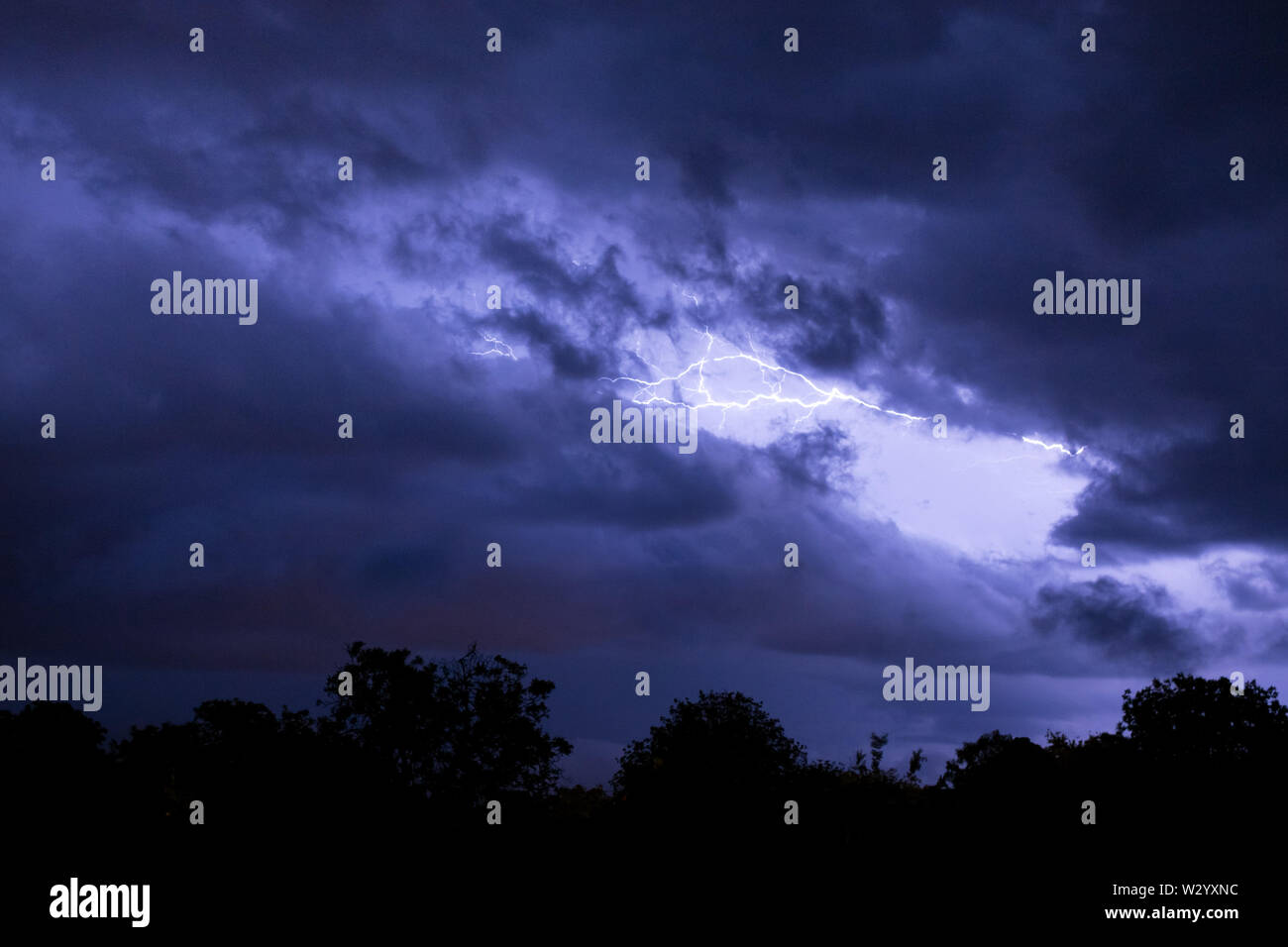 Lightning flashes over the night sky during thunderstorm Stock Photo ...