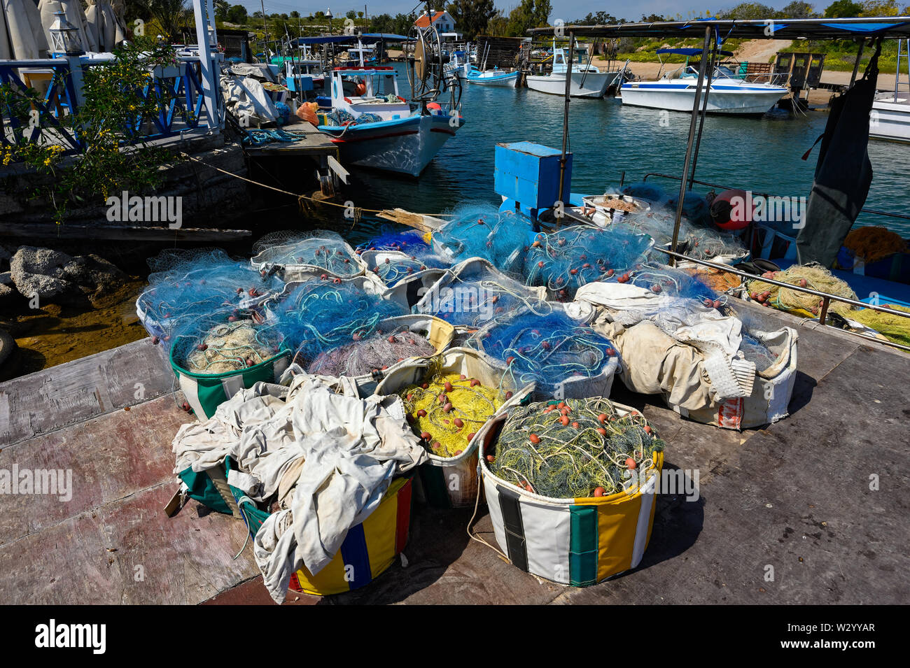Traditional wooden boats and fishing nets in the harbor of Potamos in ...