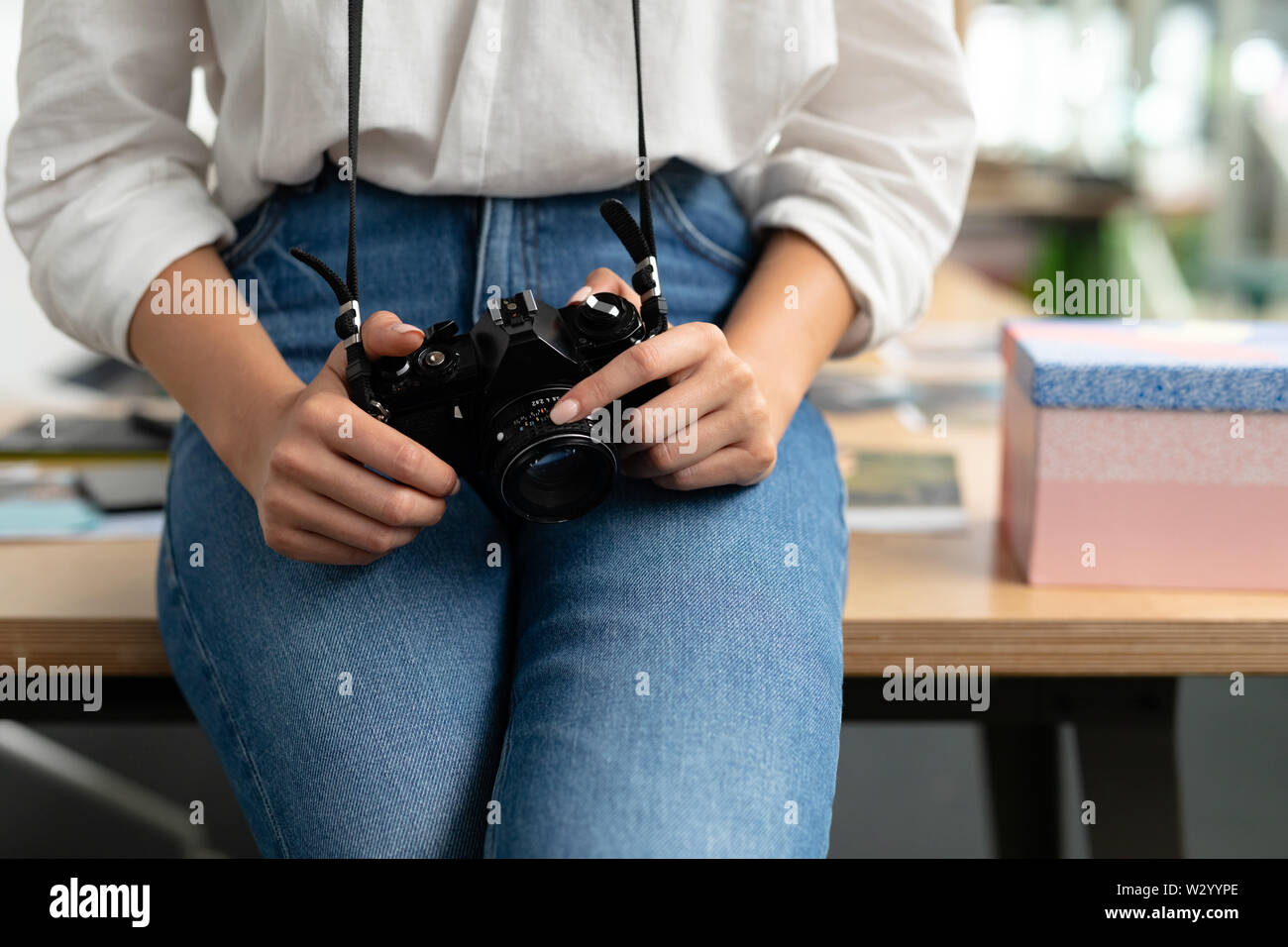 Female graphic designer holding digital camera Stock Photo - Alamy