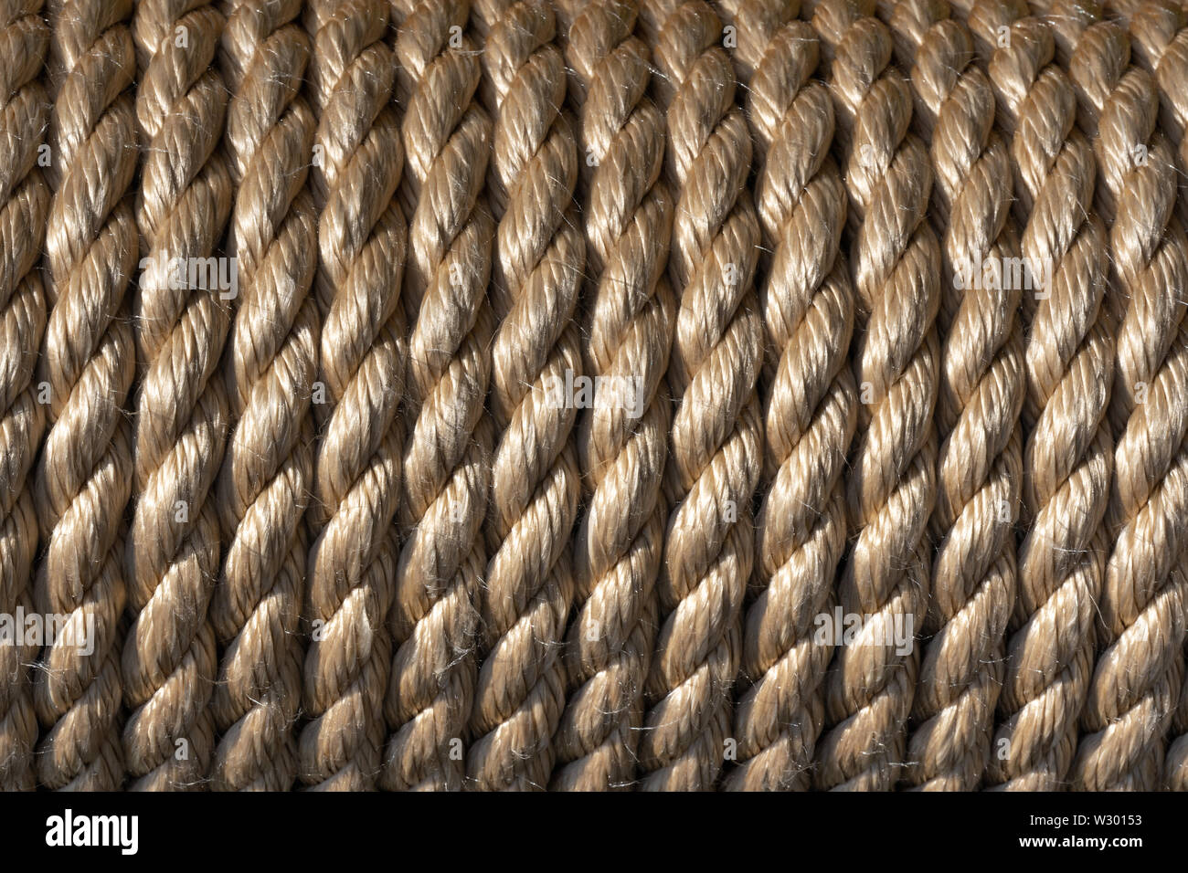 close up coiled rope forming stripes as a background with pattern of ...