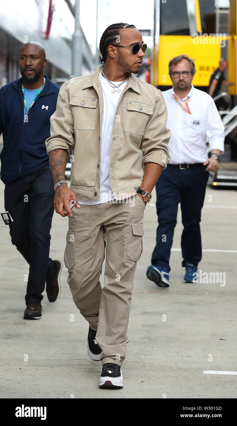 Mercedes' driver Lewis Hamilton walks through the paddock, during a ...