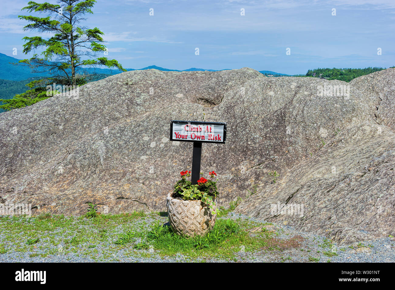 Warning sign at the top of Blowing Rock. A natural tourist attraction ...