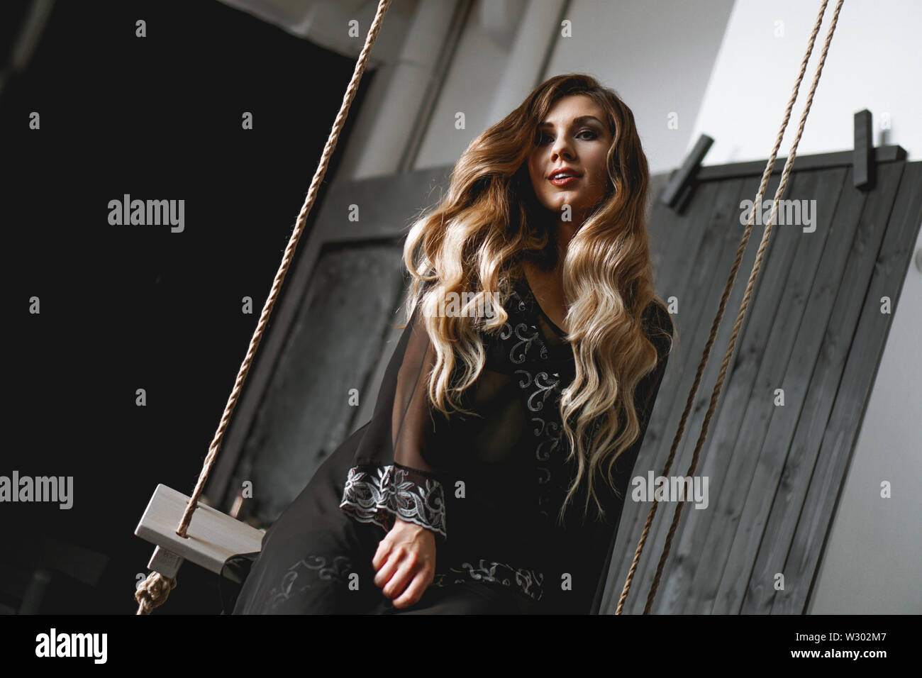Young pretty woman, wearing transparent black peignoir night gown in ...