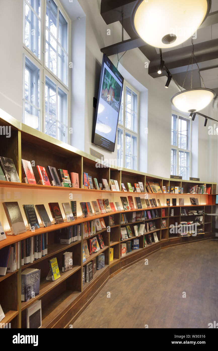 Curved wall on ground floor with illuminated display shelf. Deichman ...