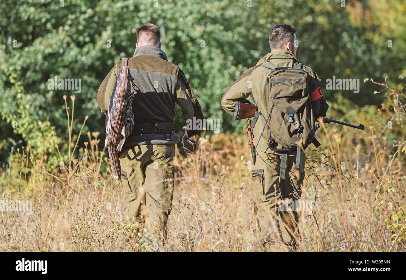 Man hunters with rifle gun. Boot camp. Military uniform. Friendship of ...