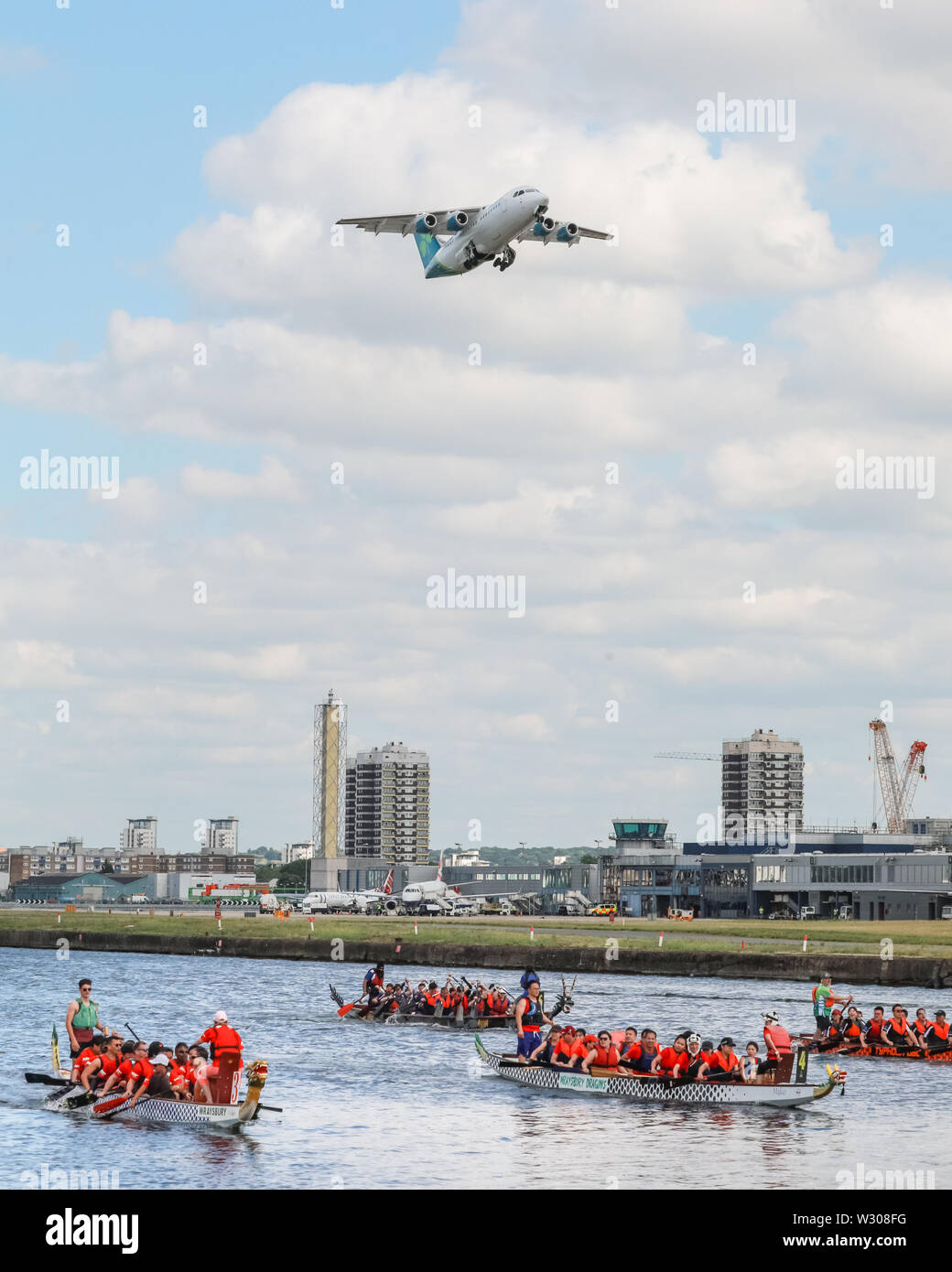 An airplane takes off from London City Airport as racers in their ...