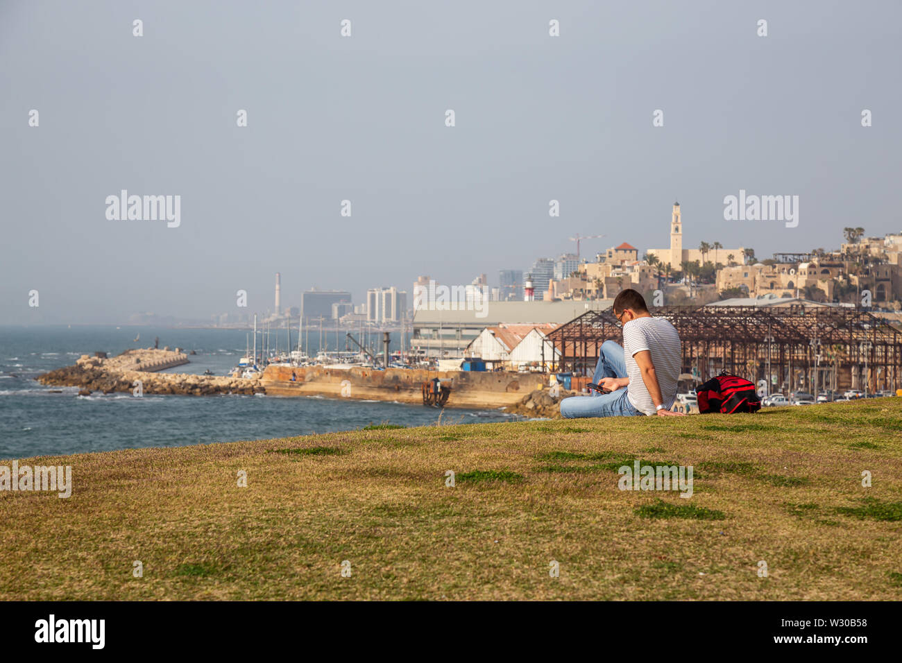Tel Aviv, Israel - April 13, 2019: Man sitting and enjoying the view of ...
