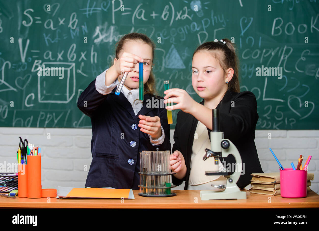 Testing blood samples. Little girls in school lab. biology education ...