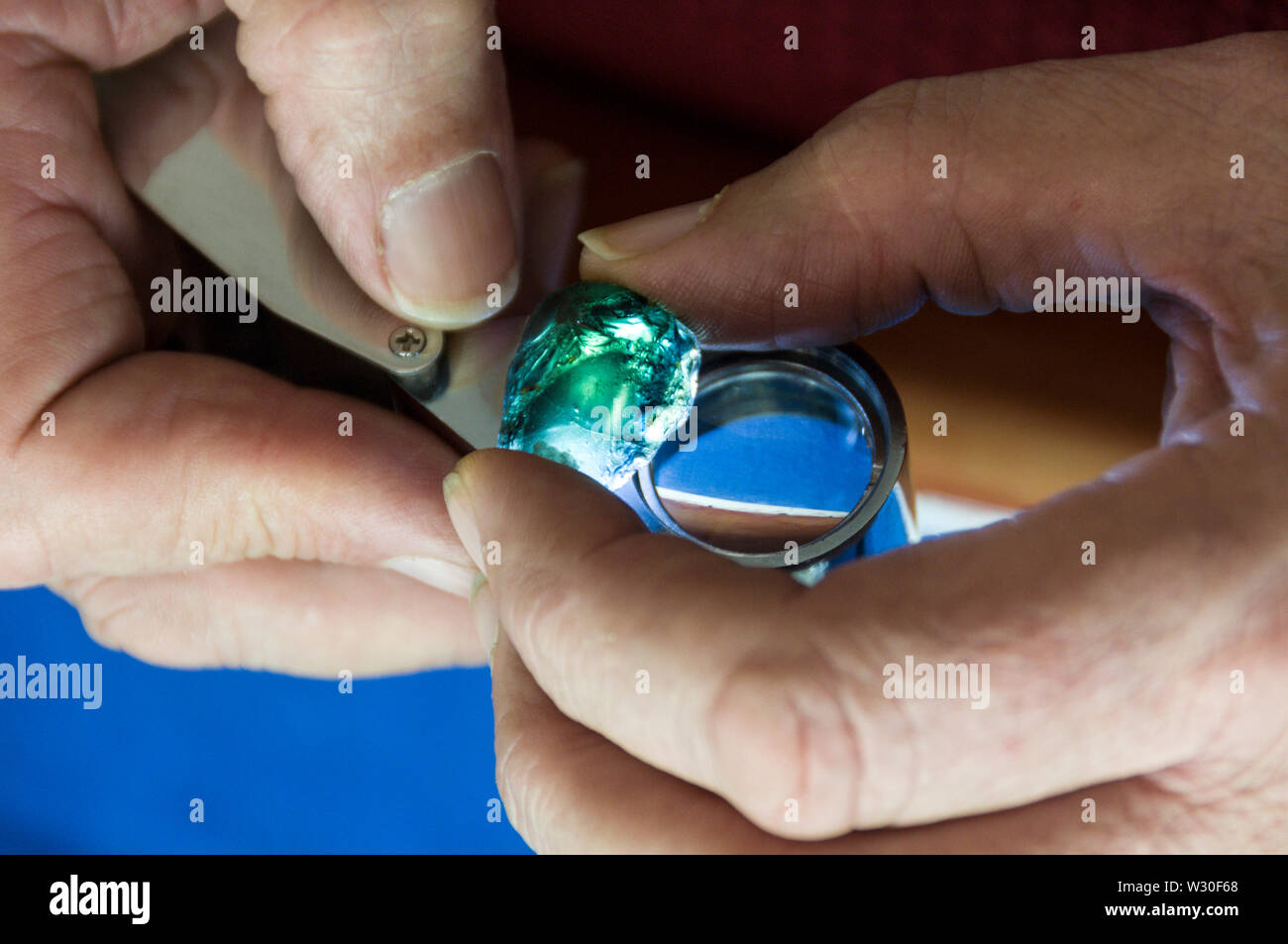 A gem cutter holds a green sapphire valued at Aus $6,000. The stone was ...
