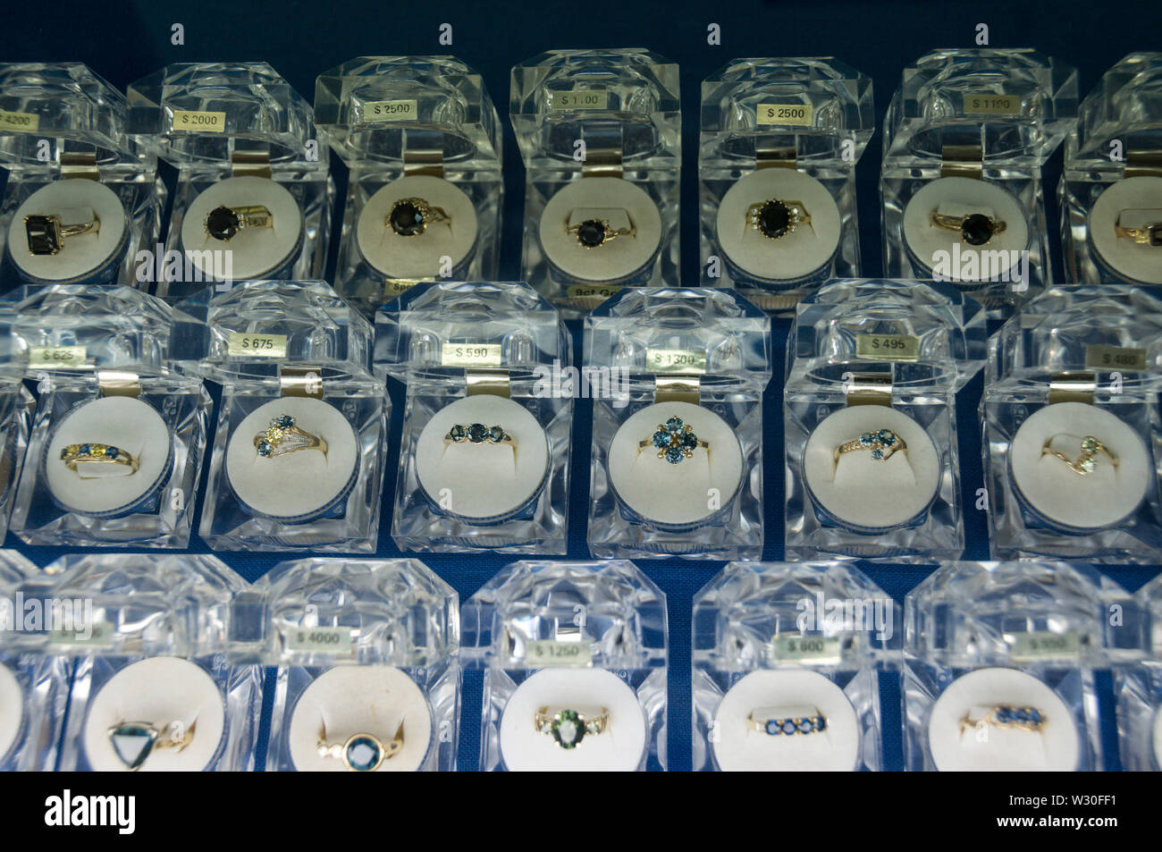 A Gem shop showcase of sapphire rings with various prices, in a small ...