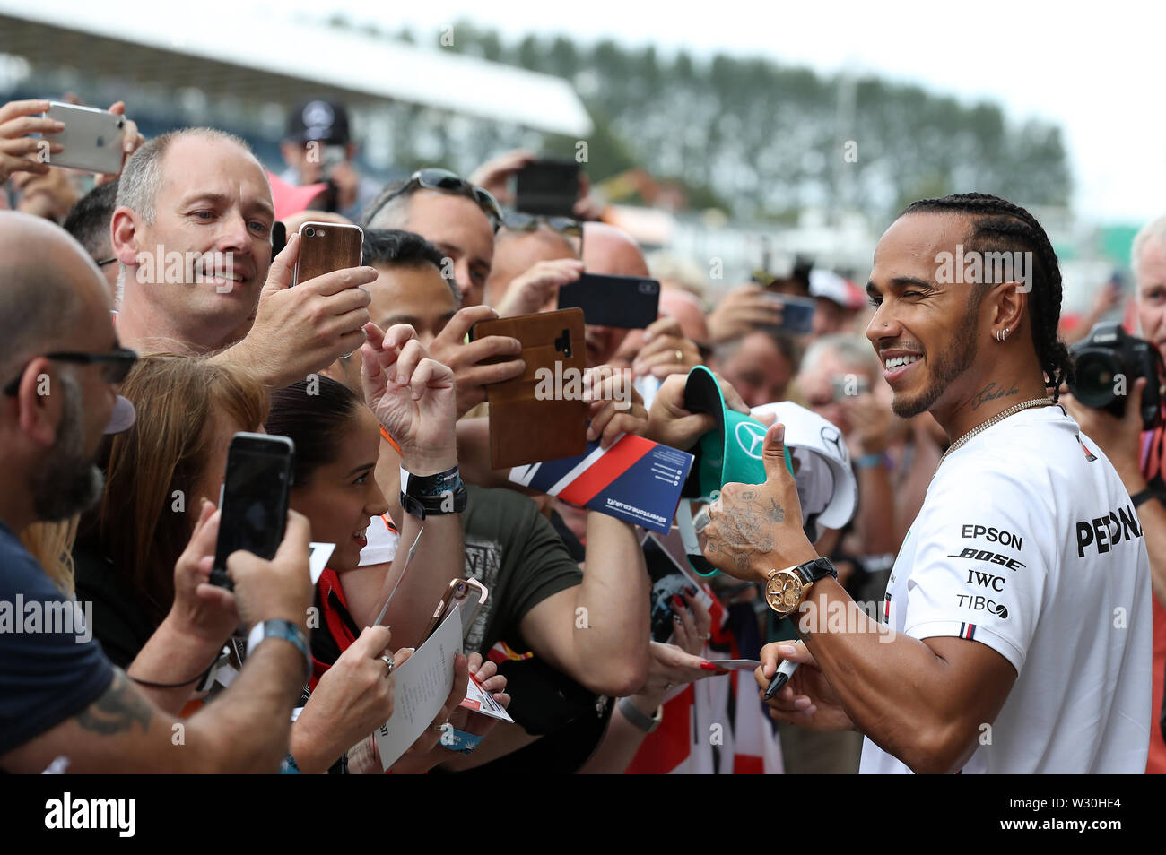 Mercedes' Lewis Hamilton gives a thumbs up to the crowd during a ...