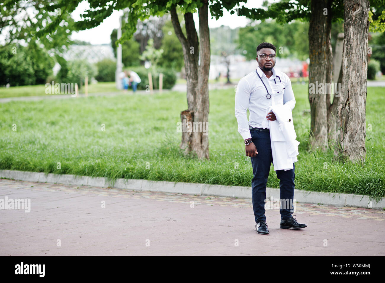 Young african american male doctor hold white coat on hand with a ...