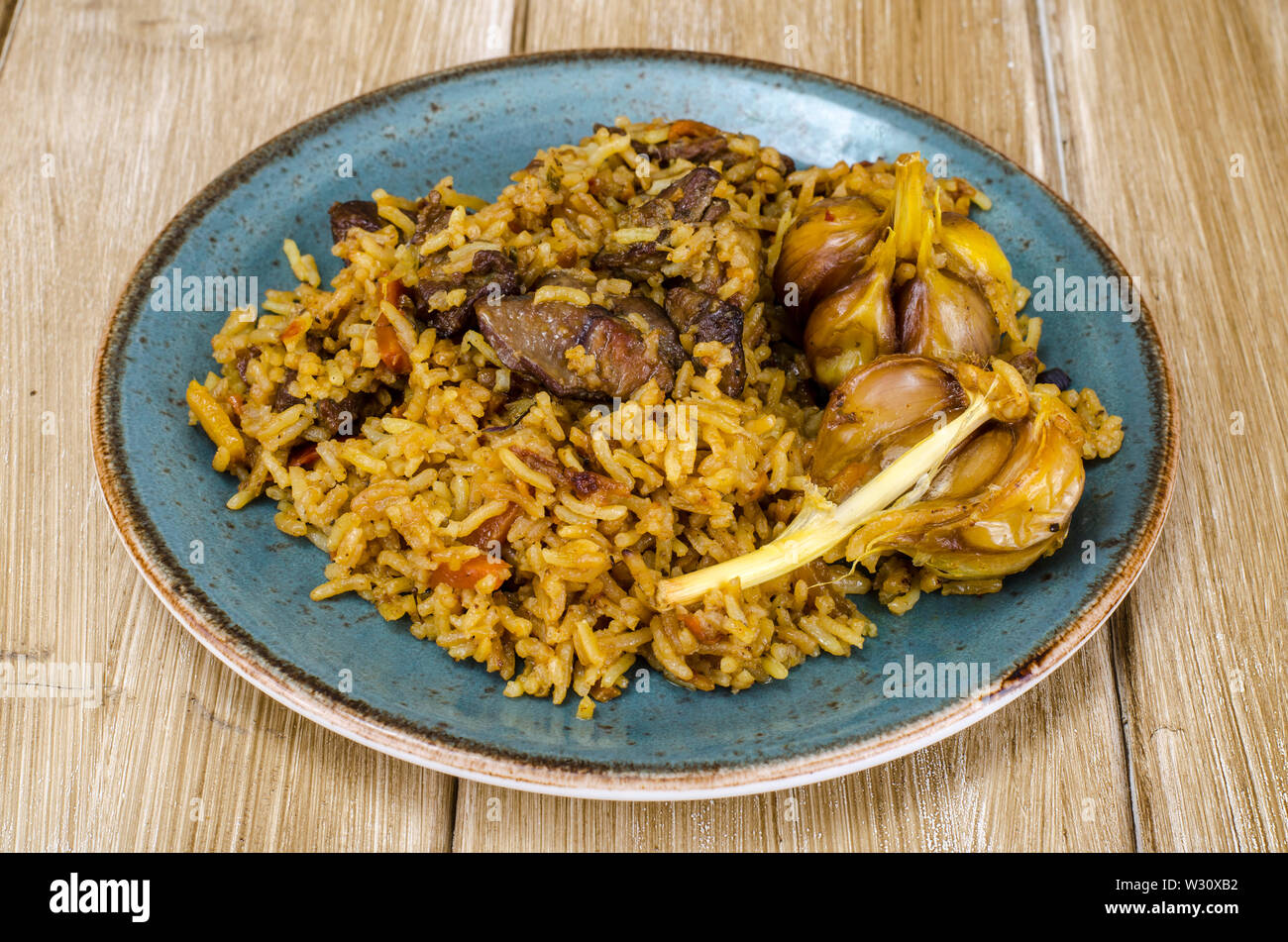 Delicious aromatic pilaf with lamb and garlic Stock Photo - Alamy