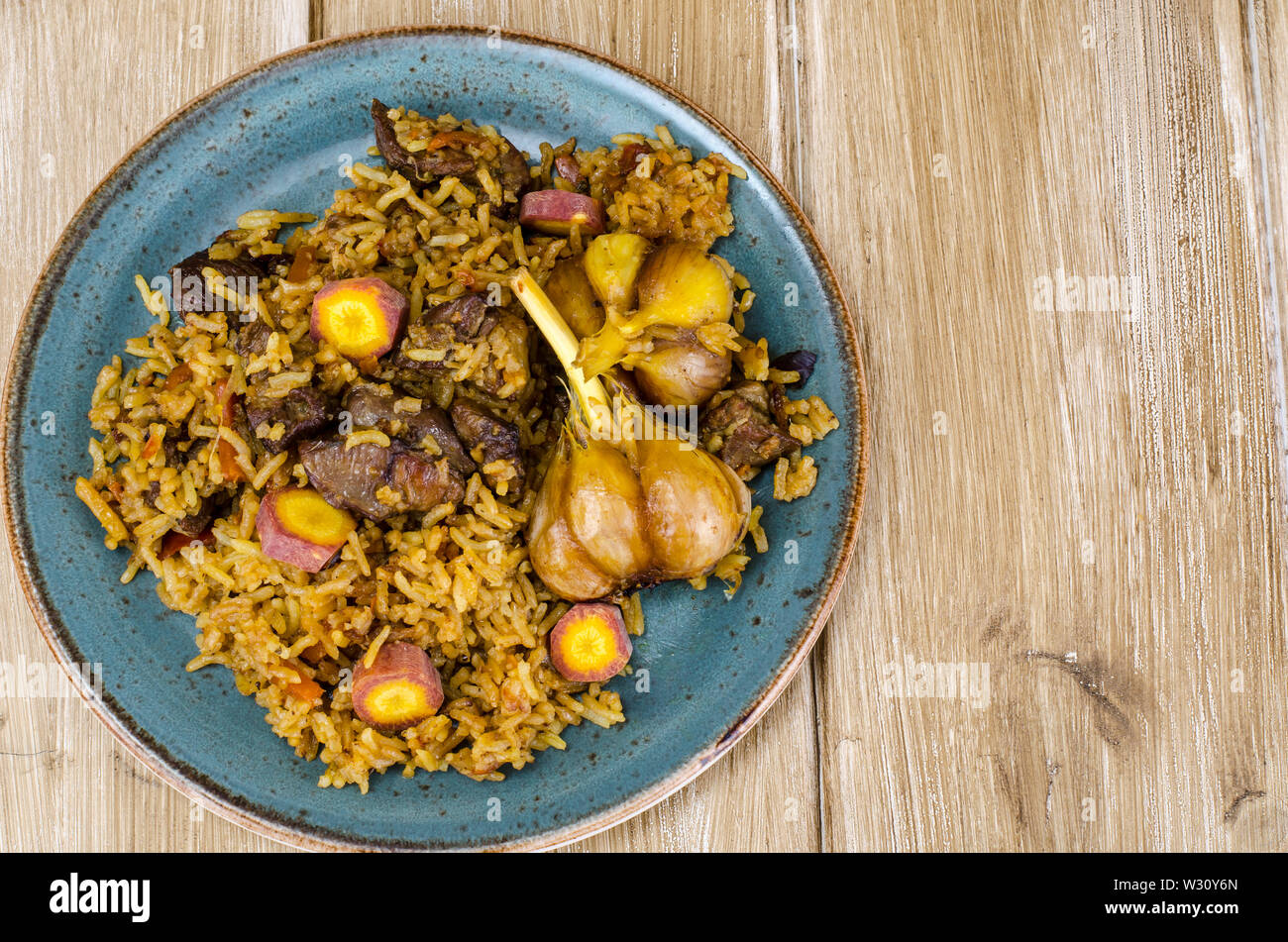 Delicious aromatic pilaf with lamb and garlic Stock Photo - Alamy