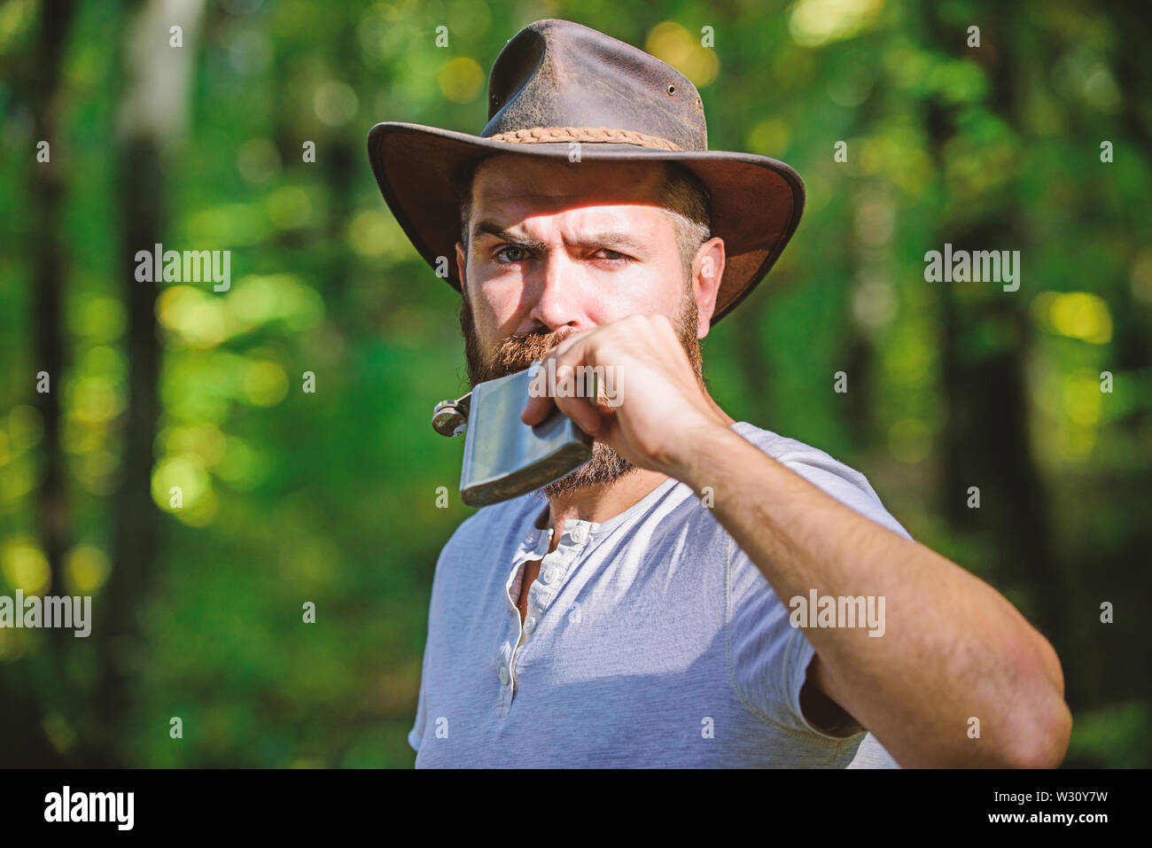 Hiking camping. Wanderer concept. Alcohol drink. Nomadic man carry ...