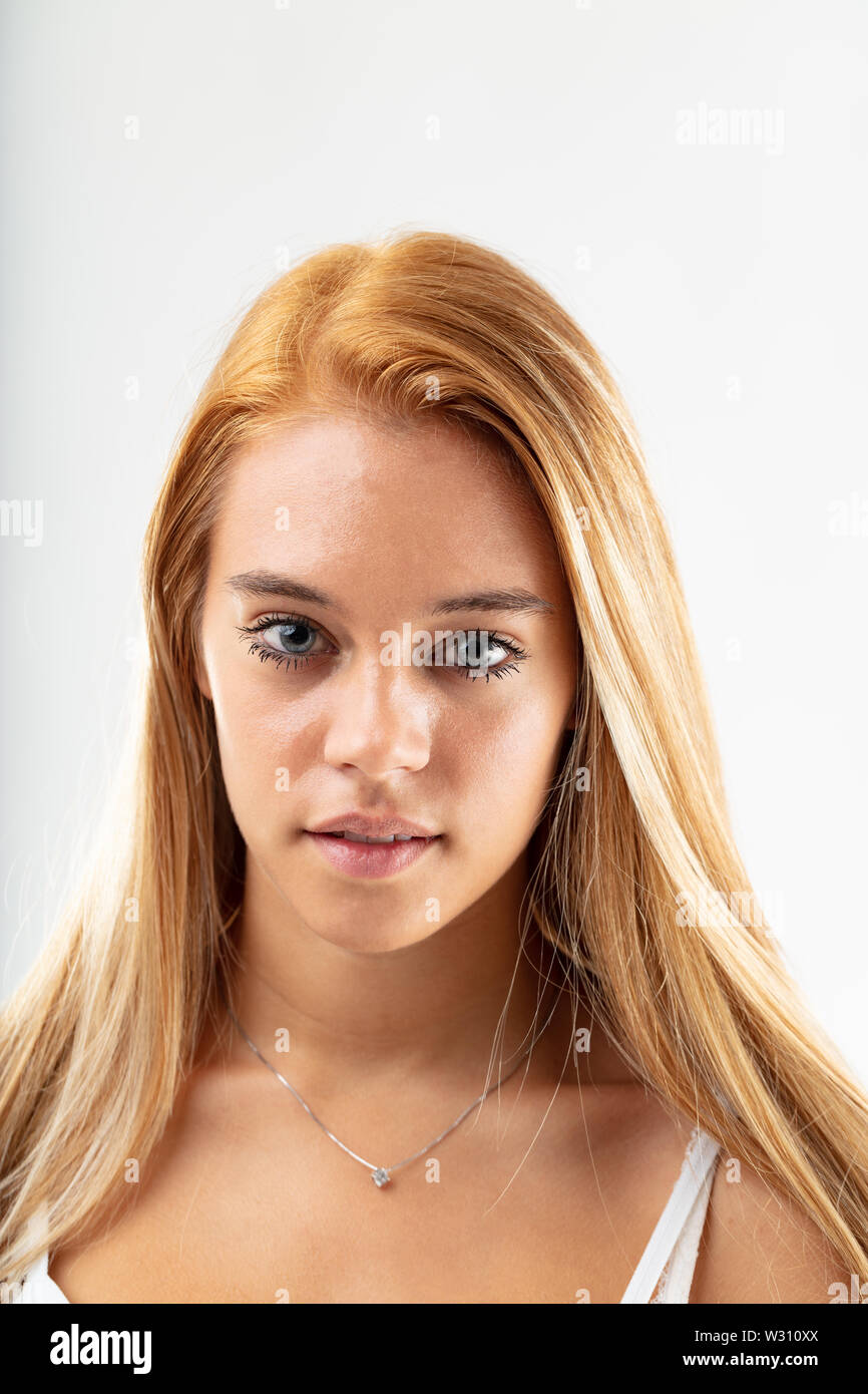 Attractive blue eyed intense young blond woman staring at the camera ...