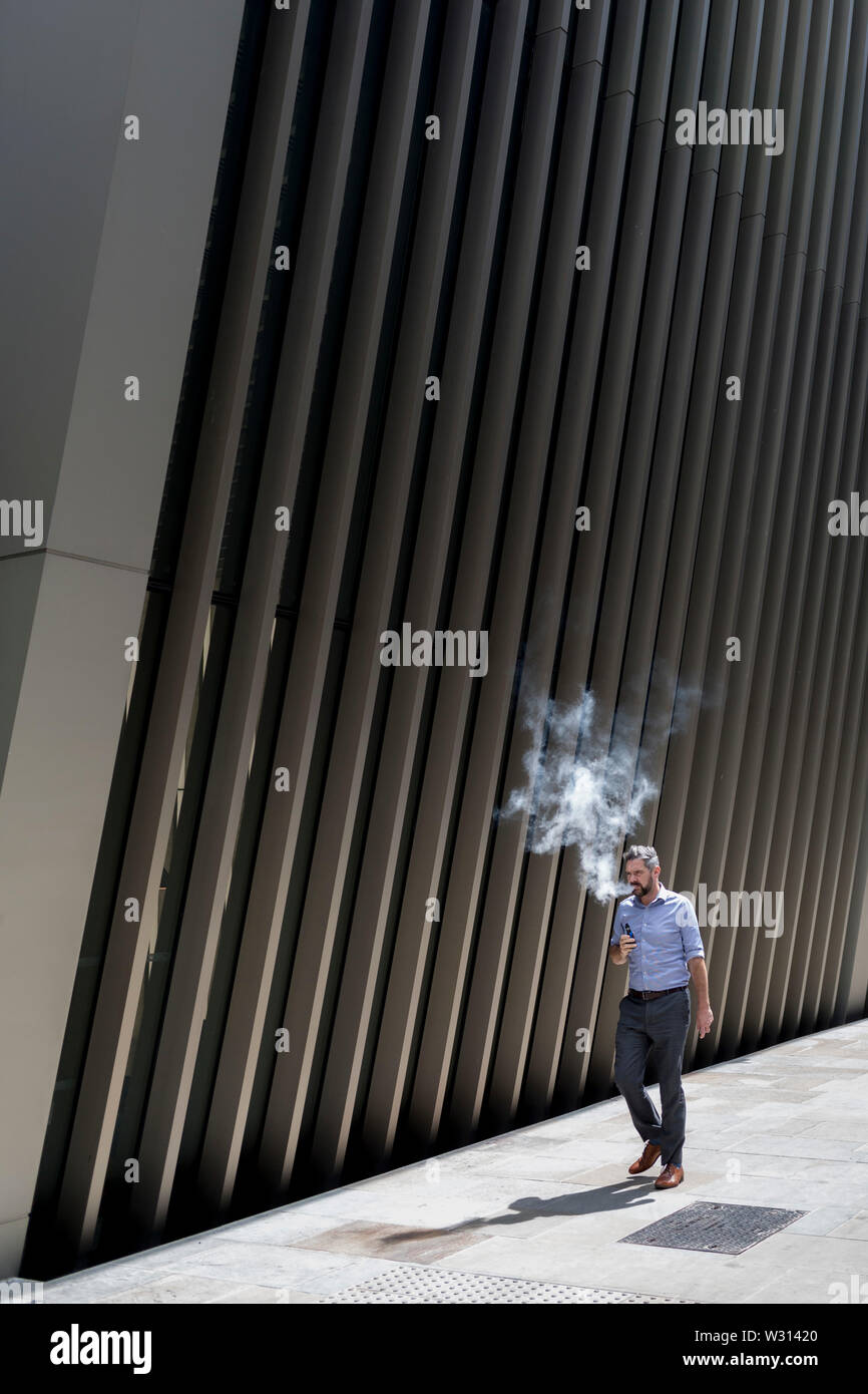 Man vaping in street hi-res stock photography and images - Alamy