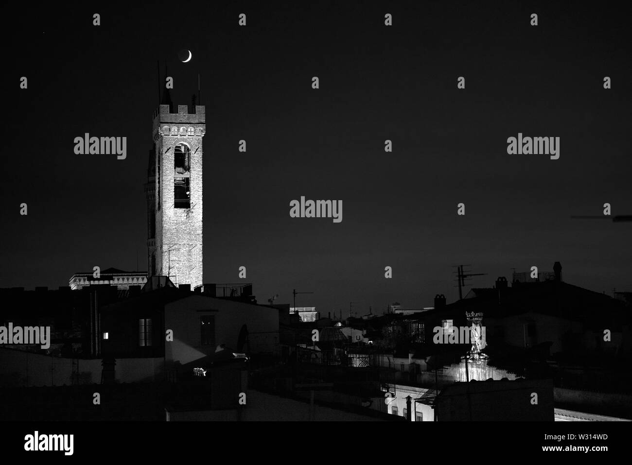 Bell Tower of Palazzo Vecchio in Florence Italy at night with crescent ...