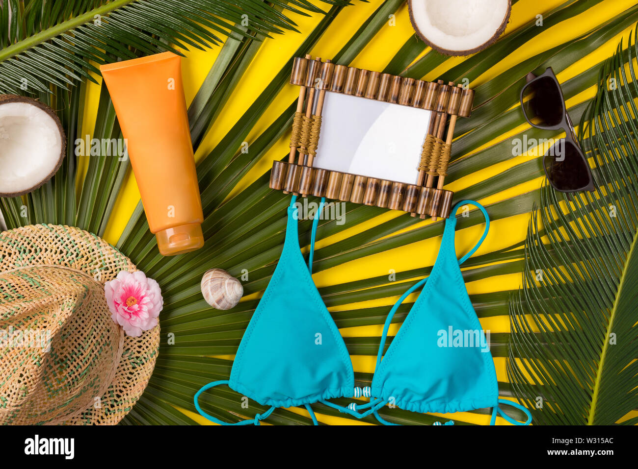 Beach theme on yellow background. Beach accessories, palm leaves, photo ...