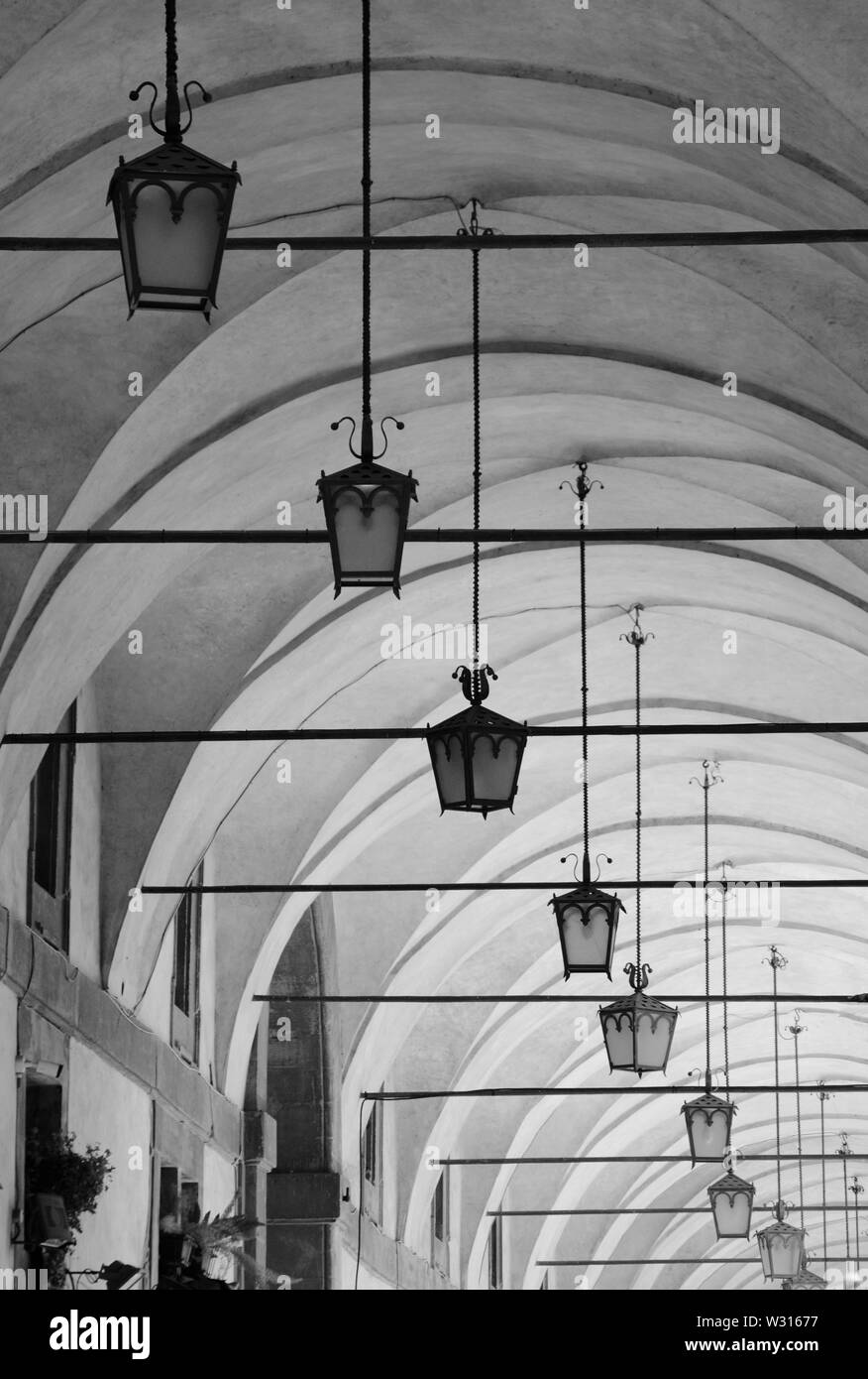 row of vintage lamps at the Logge Vasari of Arezzo town, in Tuscany ...