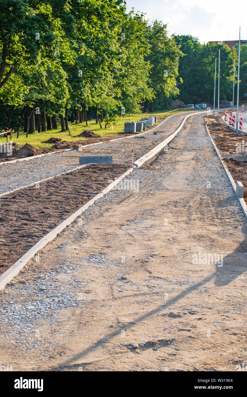 Building a new bike path with sidewalk, bicycle road under construction ...