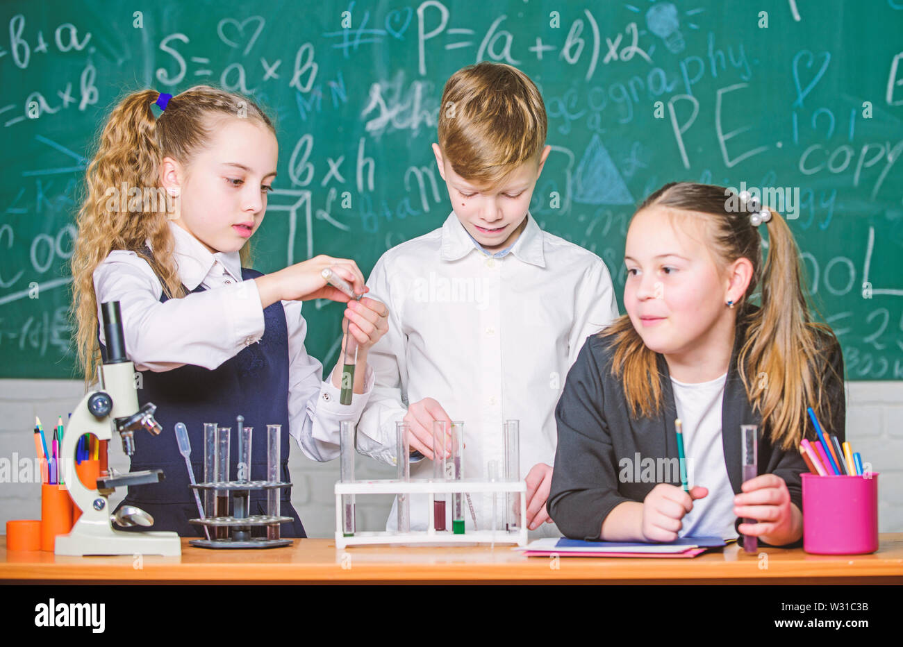 Test tubes with substances. Formal education. Girls and boy student ...