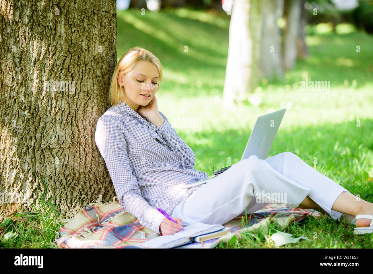 Natural environment office. Work outdoors benefits. Woman with laptop ...