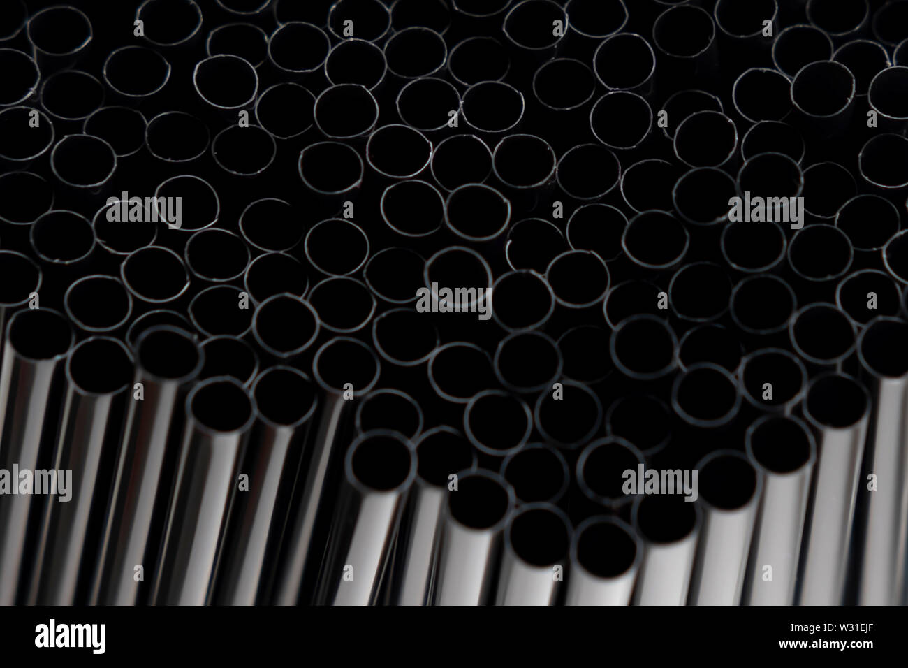 Stainless steel straws vertical abstract background. Metal pipes bundle ...