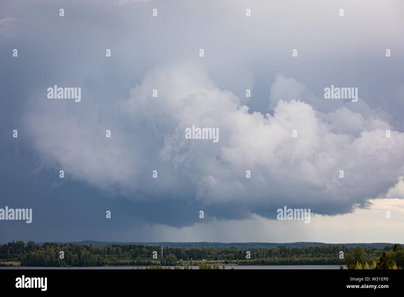 Summer day raining viewed from far Stock Photo - Alamy