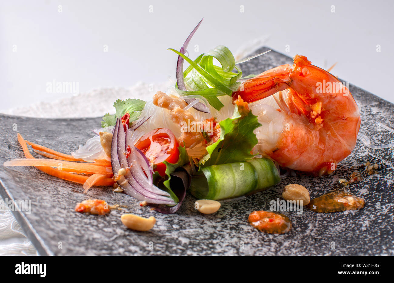 asian seald bowls and plates consisting of a thai glass noodle salad, a ...