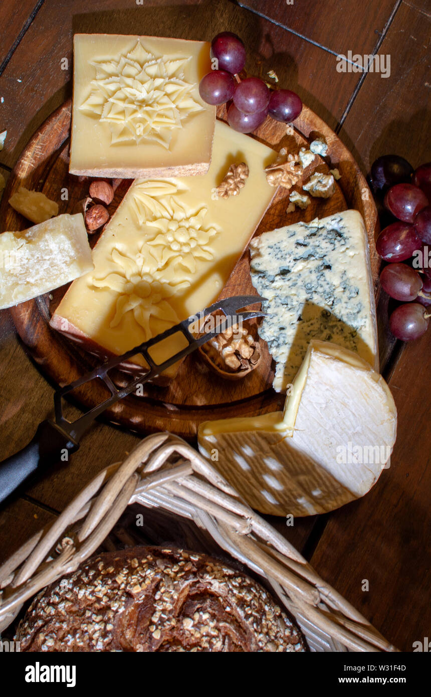 cheese various kinds with handcarved designs and patterns arranged on a ...