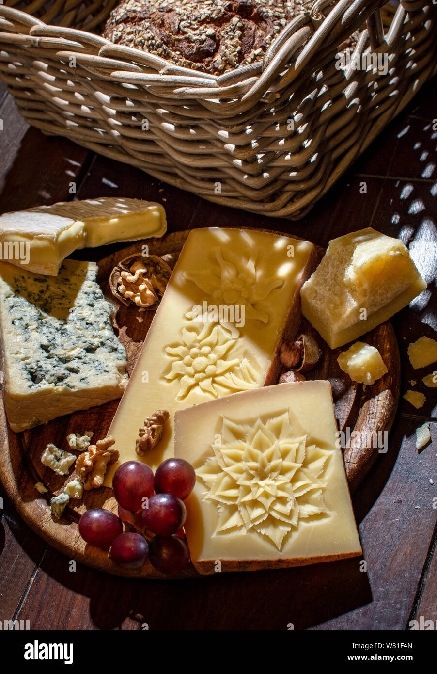 cheese various kinds with handcarved designs and patterns arranged on a ...