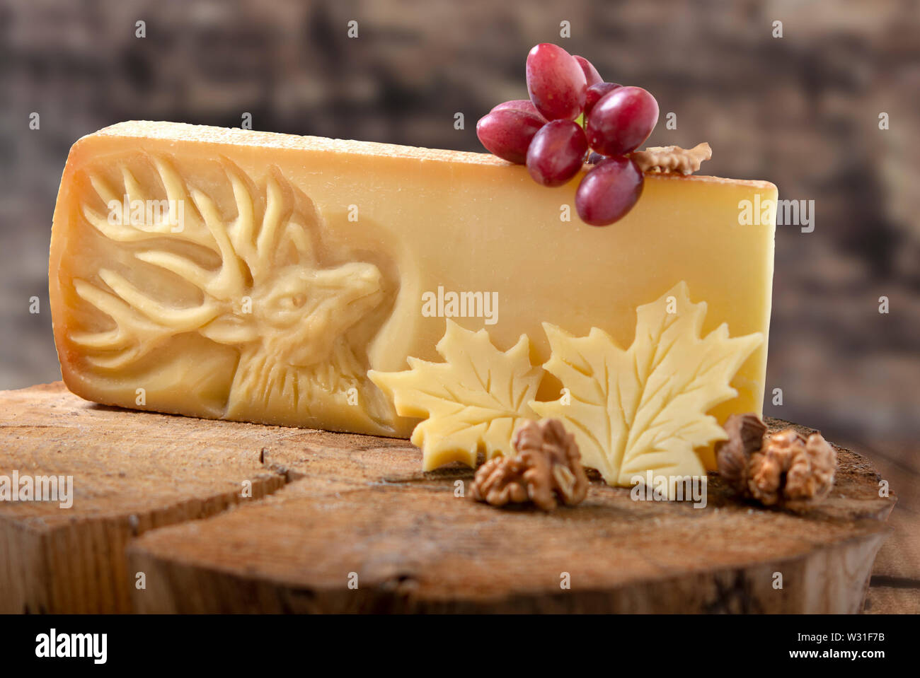 cheese various kinds with handcarved designs and patterns arranged on a ...