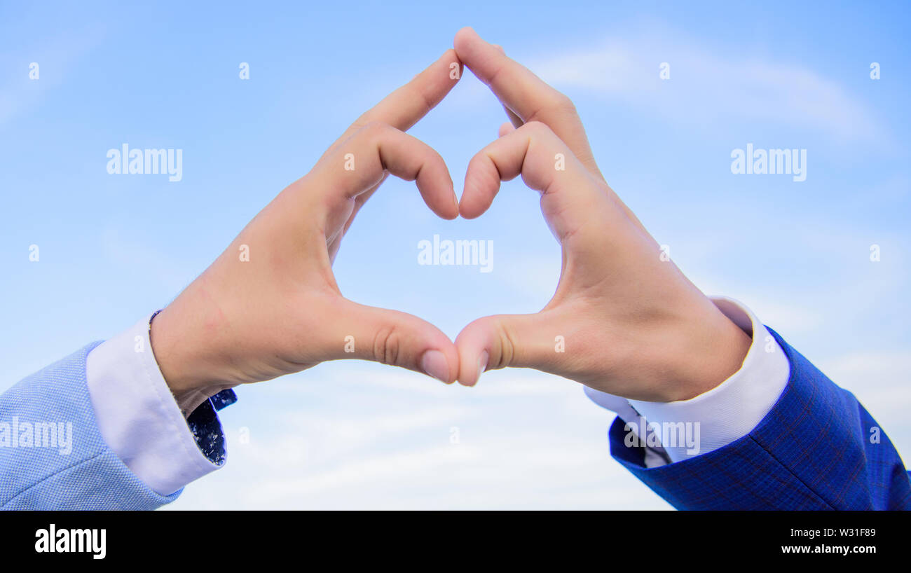 Hand heart gesture forms shape using fingers. Hands put together in ...