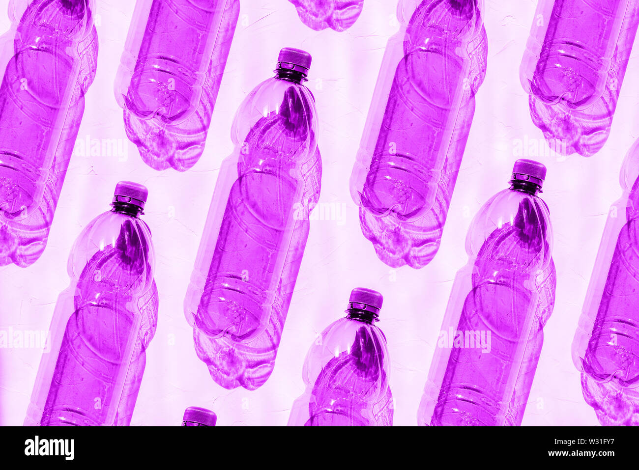 Empty plastic bottles of purple. On the plastic bottle shines a bright ...