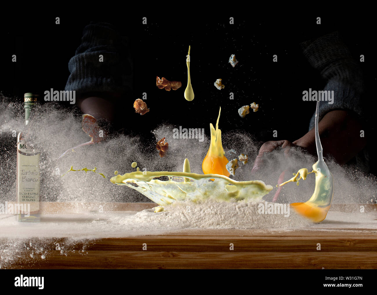 making dough with flour splashing and eggs crashing. kneating by hand ...