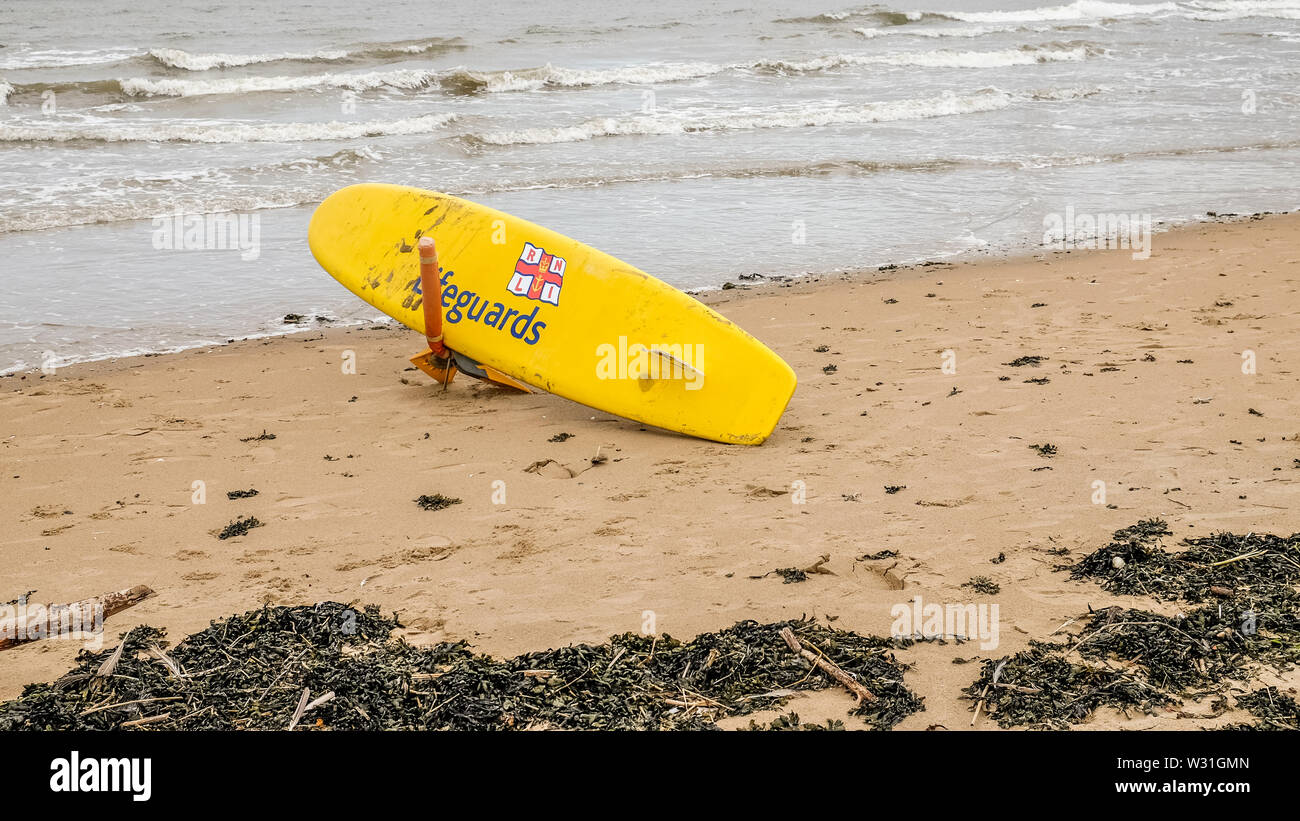 Lifeguards surfboard laid ready for action at New Brighton Stock Photo ...